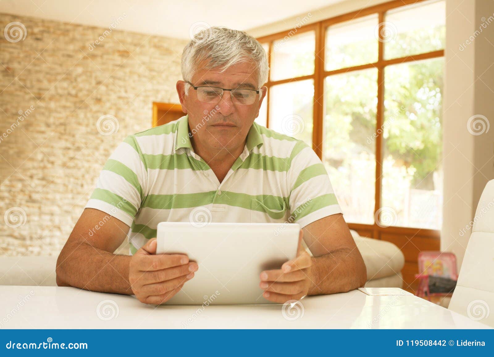 Older Man Using an Electronic Tablet. Stock Photo - Image of reading ...