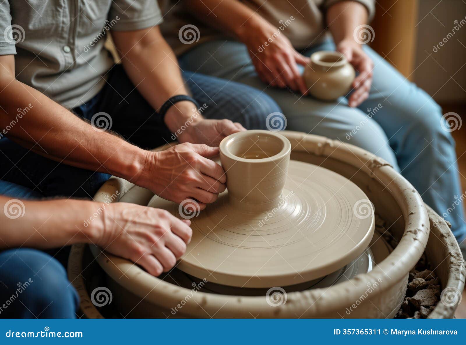 Older People Create Pottery Together in Workshop. Shape Clay on Spinning Wheel. Hands Work ...