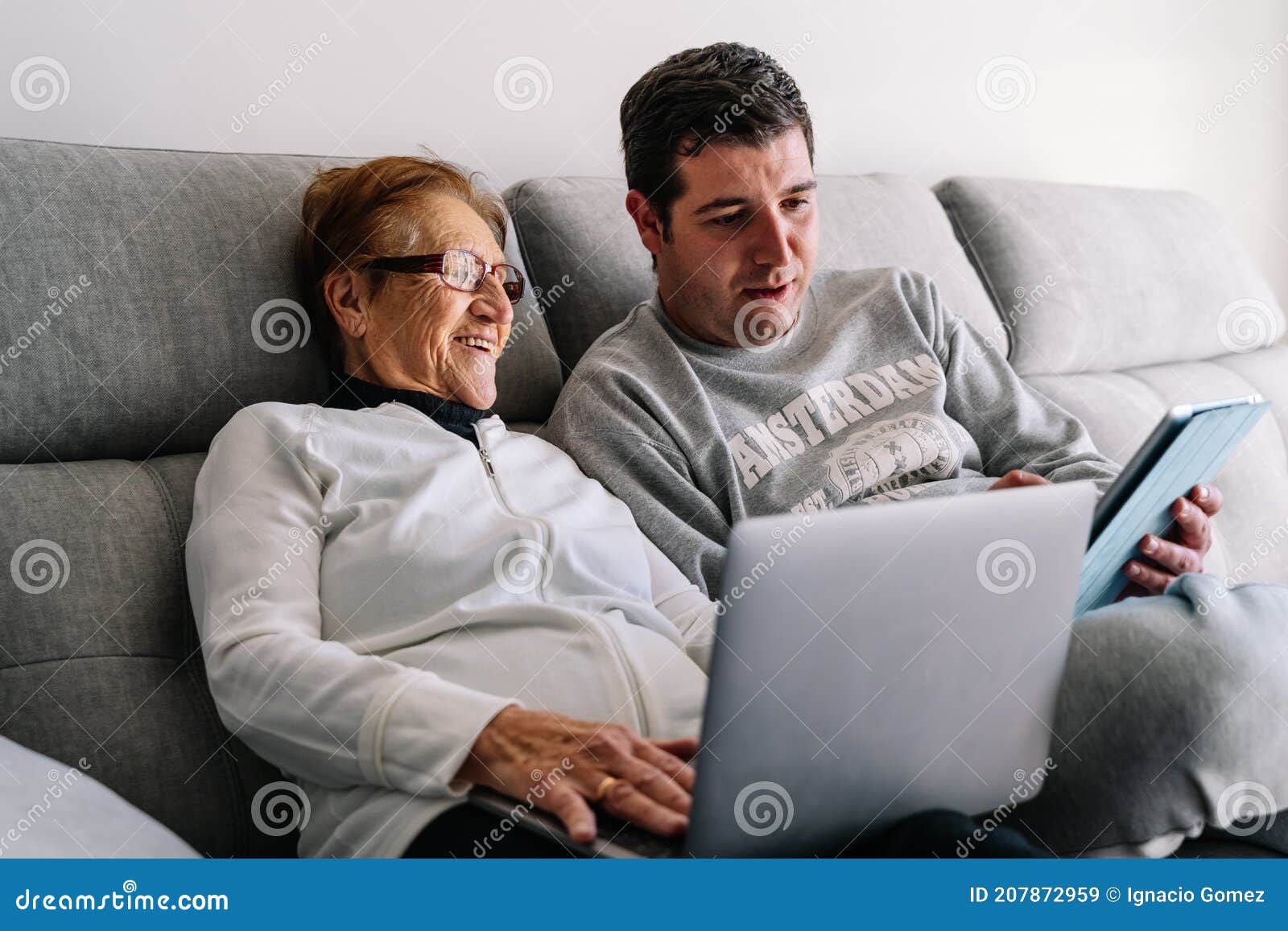 Older Person is Learning To Use New Technologies with Her Grandson ...