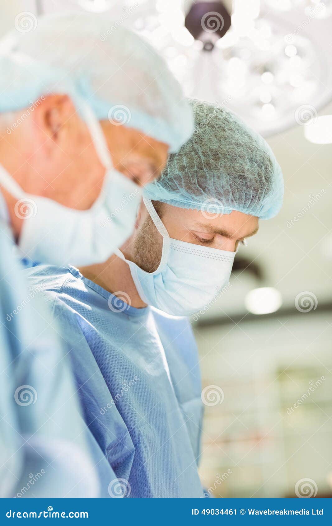 Older Surgeon Teaching New Surgeon How To Operate Stock Image - Image ...