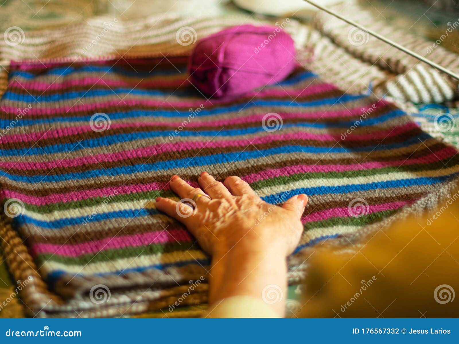 Grandmother`s Hand Testing The Softness Of Her Own Wool Garment Stock