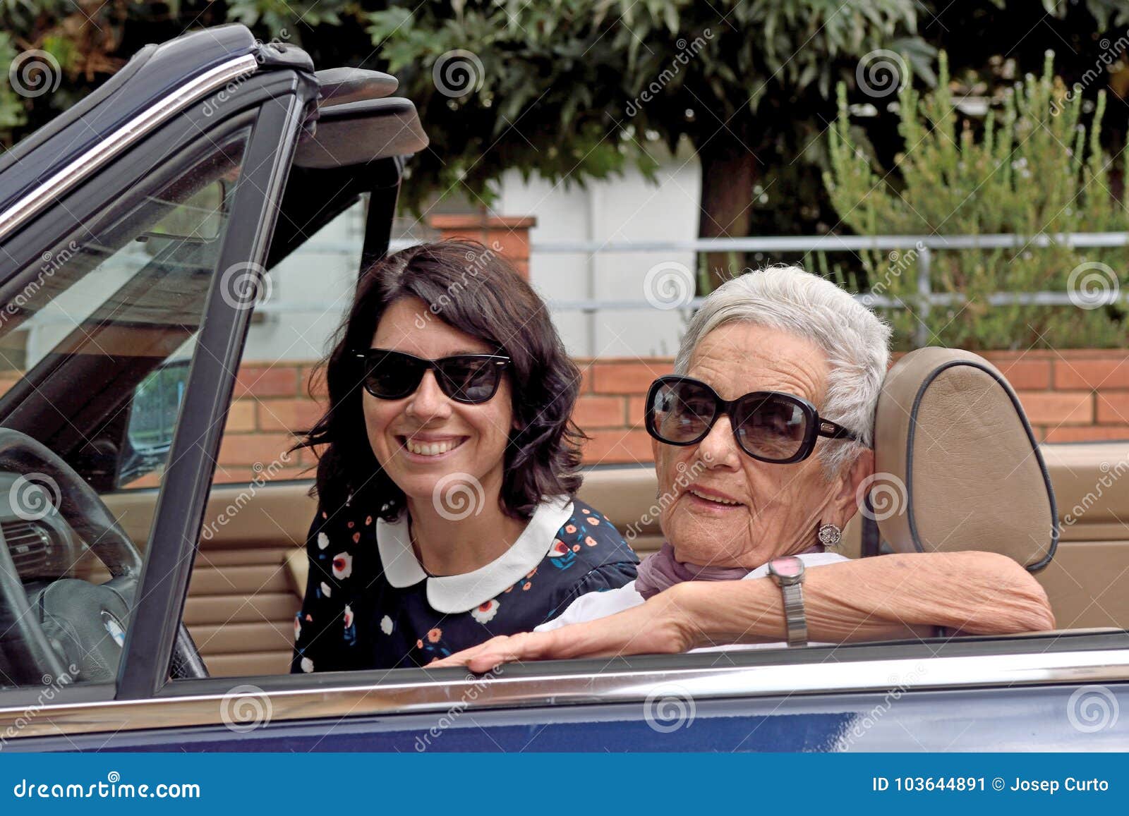 An Older Woman And A Young Woman Driving A Convertible Stock Image