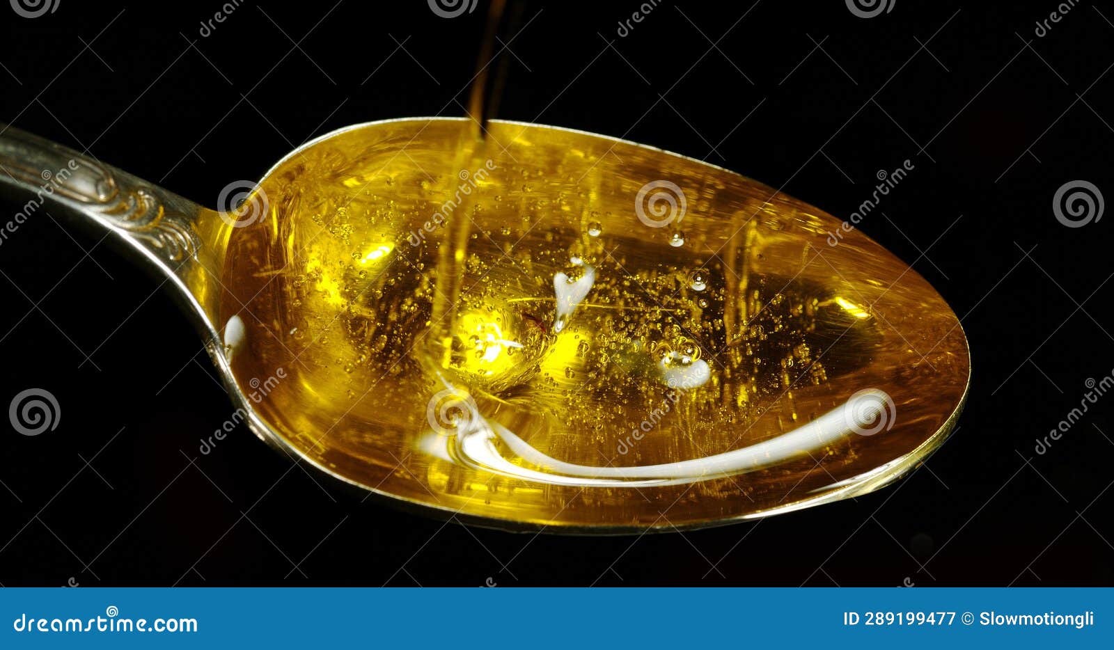 Olive Oil, Falling in a Spoon Against Black Background Stock Image ...