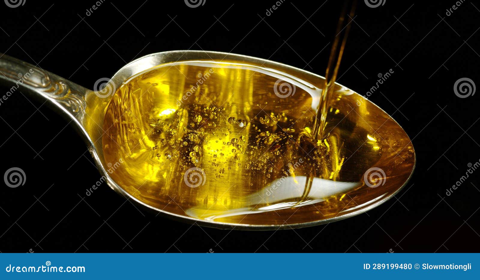 Olive Oil, Falling in a Spoon Against Black Background Stock Photo ...