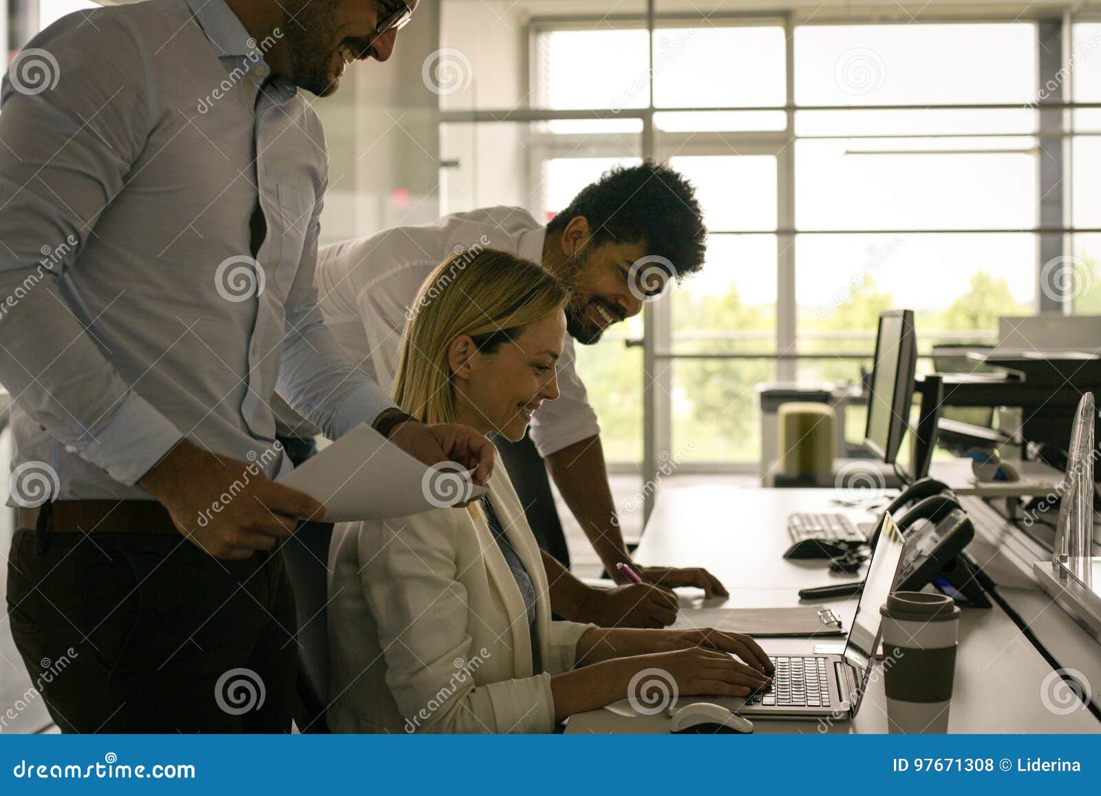 .olleague in Office Using Computer an Checking Document. B Stock Photo ...