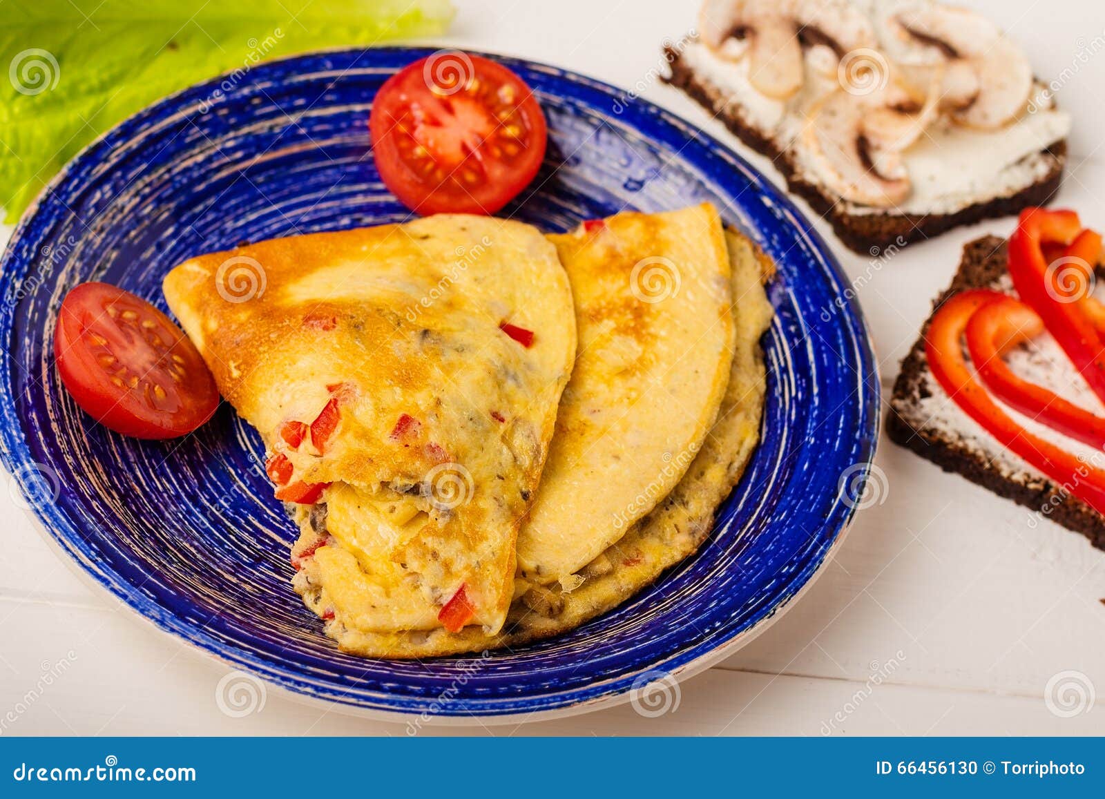 Omelet in a blue plate stock photo. Image of organic - 66456130