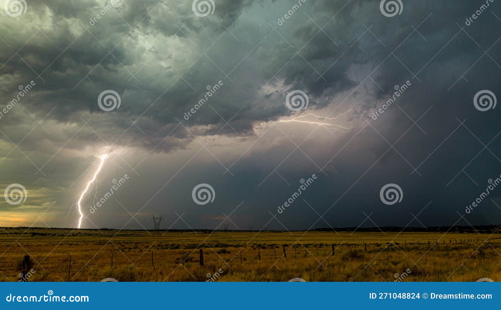 A Powerful Lightning Bolt Strikes the Ground in an Open Field Below ...