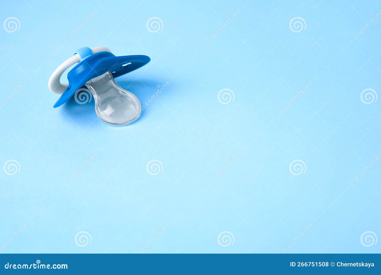 One Baby Pacifier on Light Blue Background. Space for Text Stock Photo ...