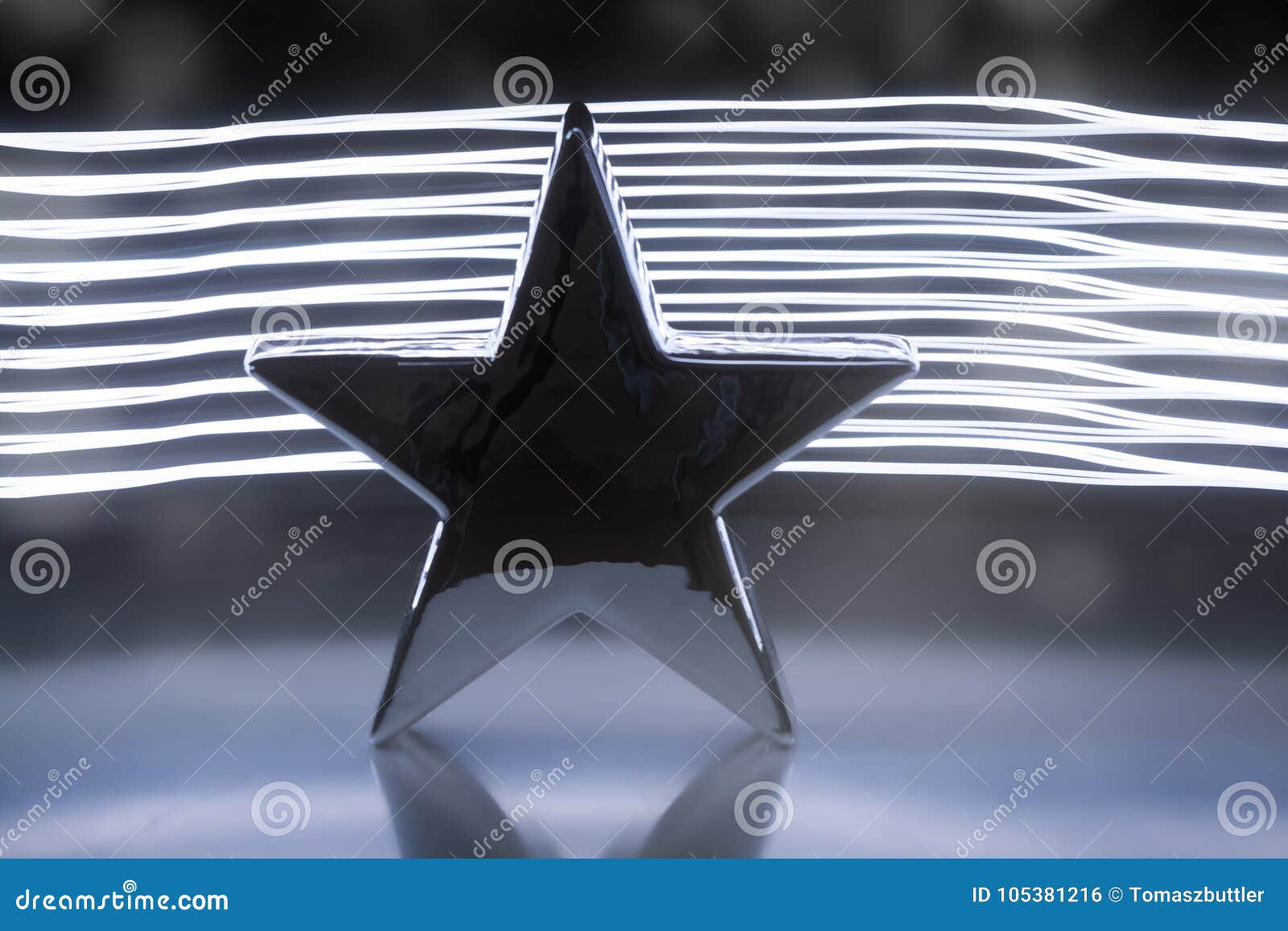 One Big Silver Metallic Star on a Dark Background with Light Effects ...