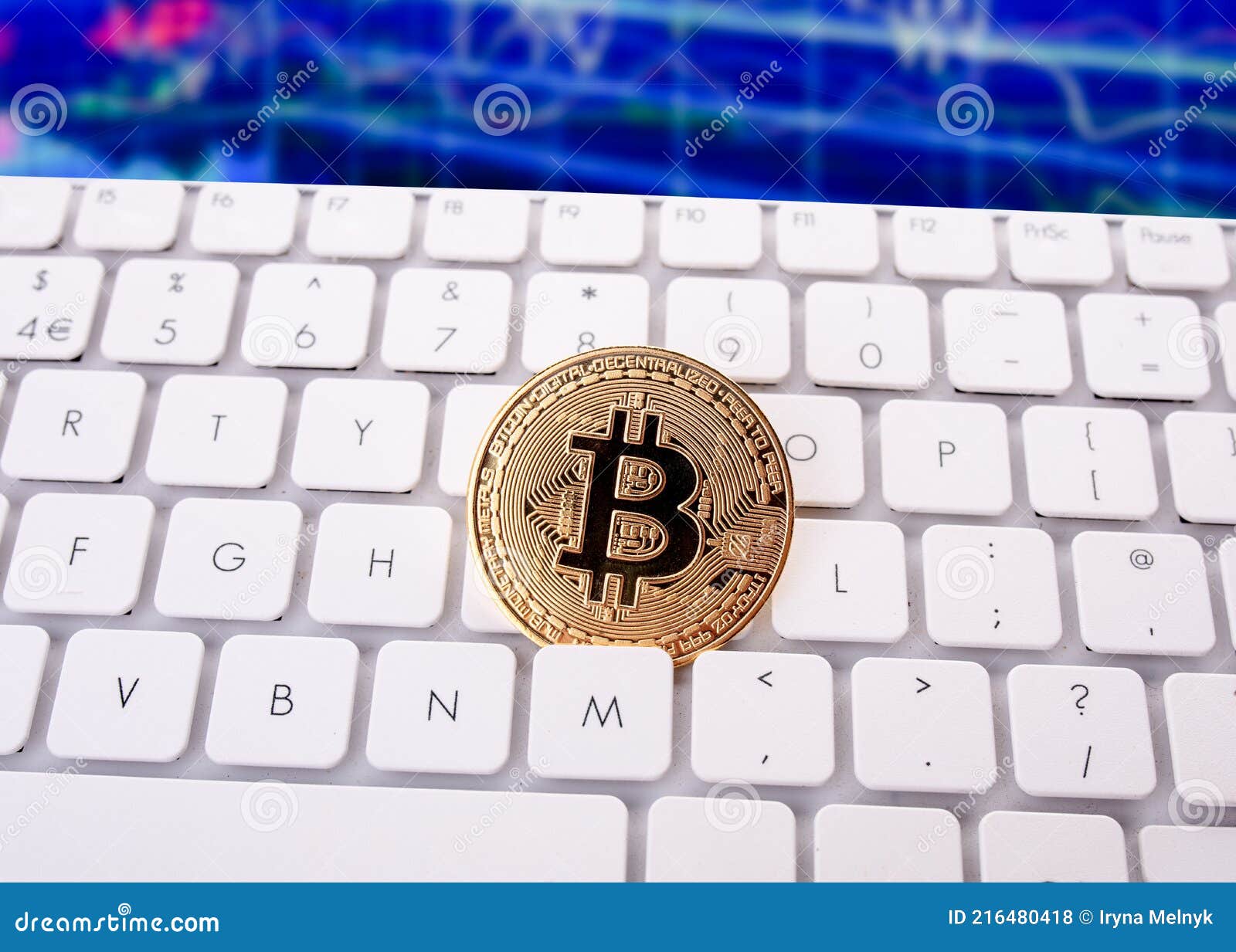One Bitcoin on a White Keyboard on Desk Against Computer Screen Stock ...