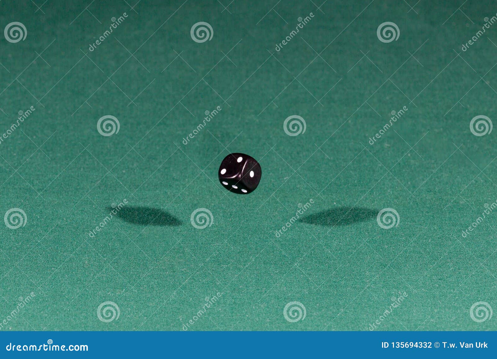 One Black Dice Falling on a Green Table Stock Photo - Image of gaming ...