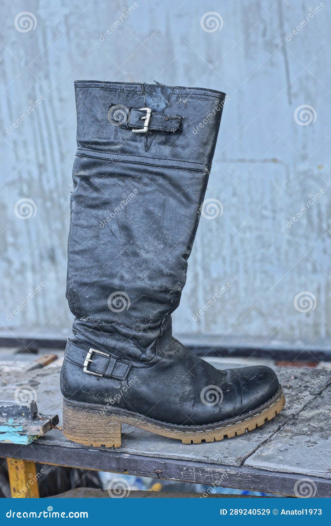 One Black Old Leather Boot Stands on a Gray Table Stock Image - Image ...