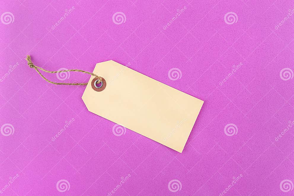 One Blank Gift Tags with a String Lying on a Pink Background Made of ...