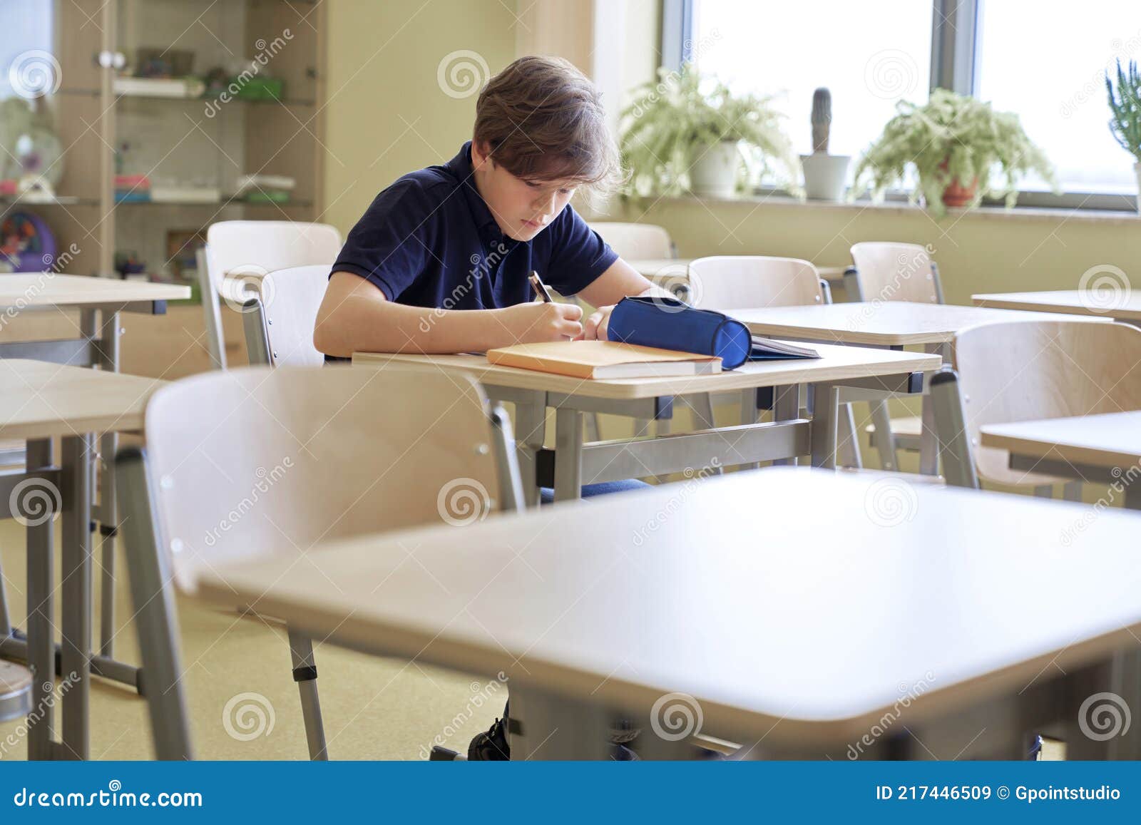 One Student Sitting and Learning Alone in Empty Classroom Stock Image ... One Student Sitting and Learning Alone in Empty Classroom Stock Image ...