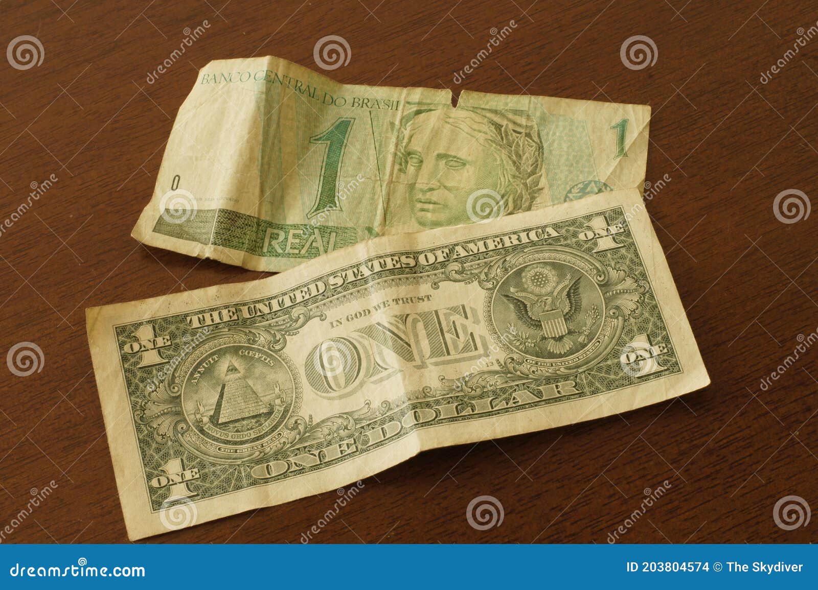 One Brazilian Real and One Dollar Bill on the Table. Stock Photo ...