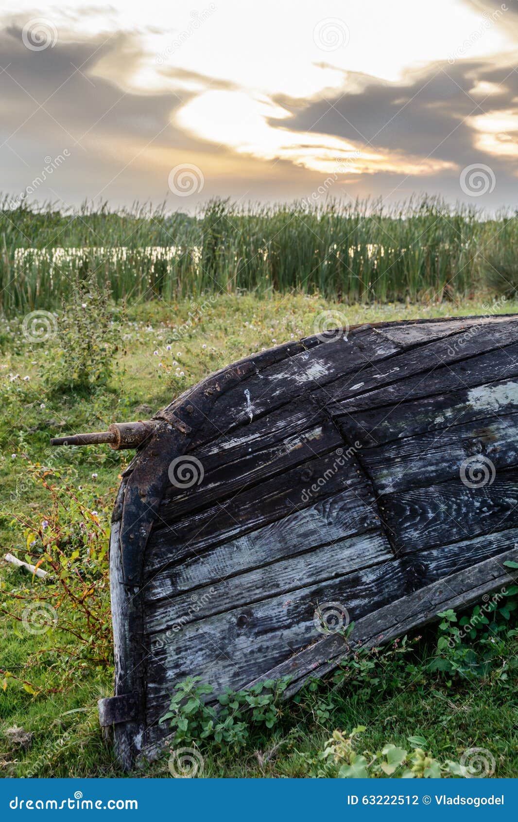 One Cracked, Old Boat, Turned Upside Down On The Shore. Vertical Stock ...