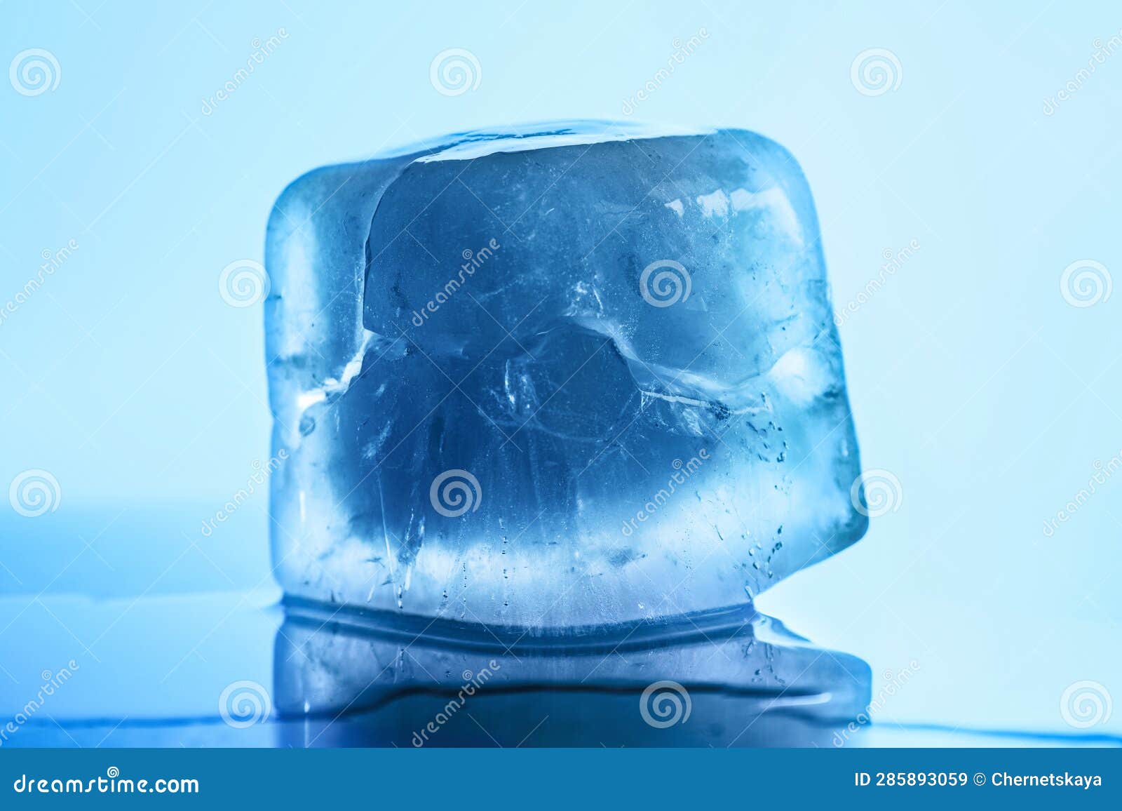 One Crystal Clear Ice Cube on Light Blue Background, Closeup. Color ...