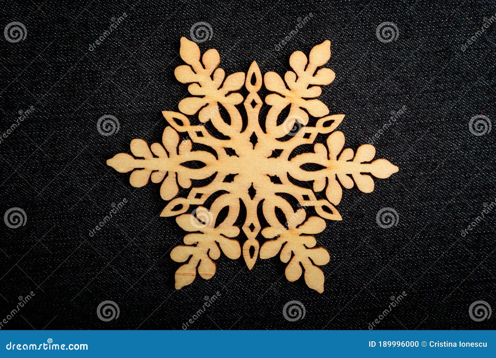 One Delicate Light Brown Wooden Snowflake on Black Textile Material ...