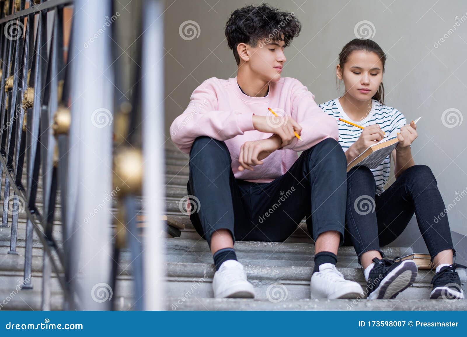 One of Diligent Learners Making Notes while Both Reading Passage from ...