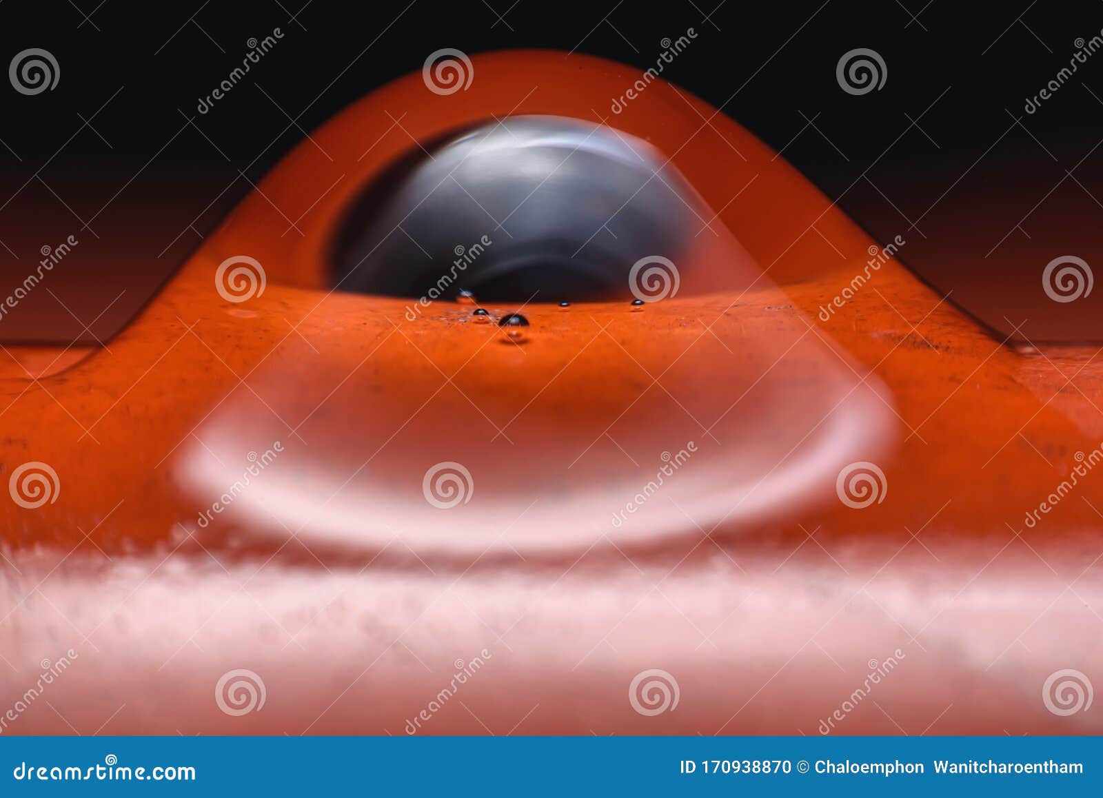 One Drop of Water is Dropping Over a Red Object with a Black Background ...