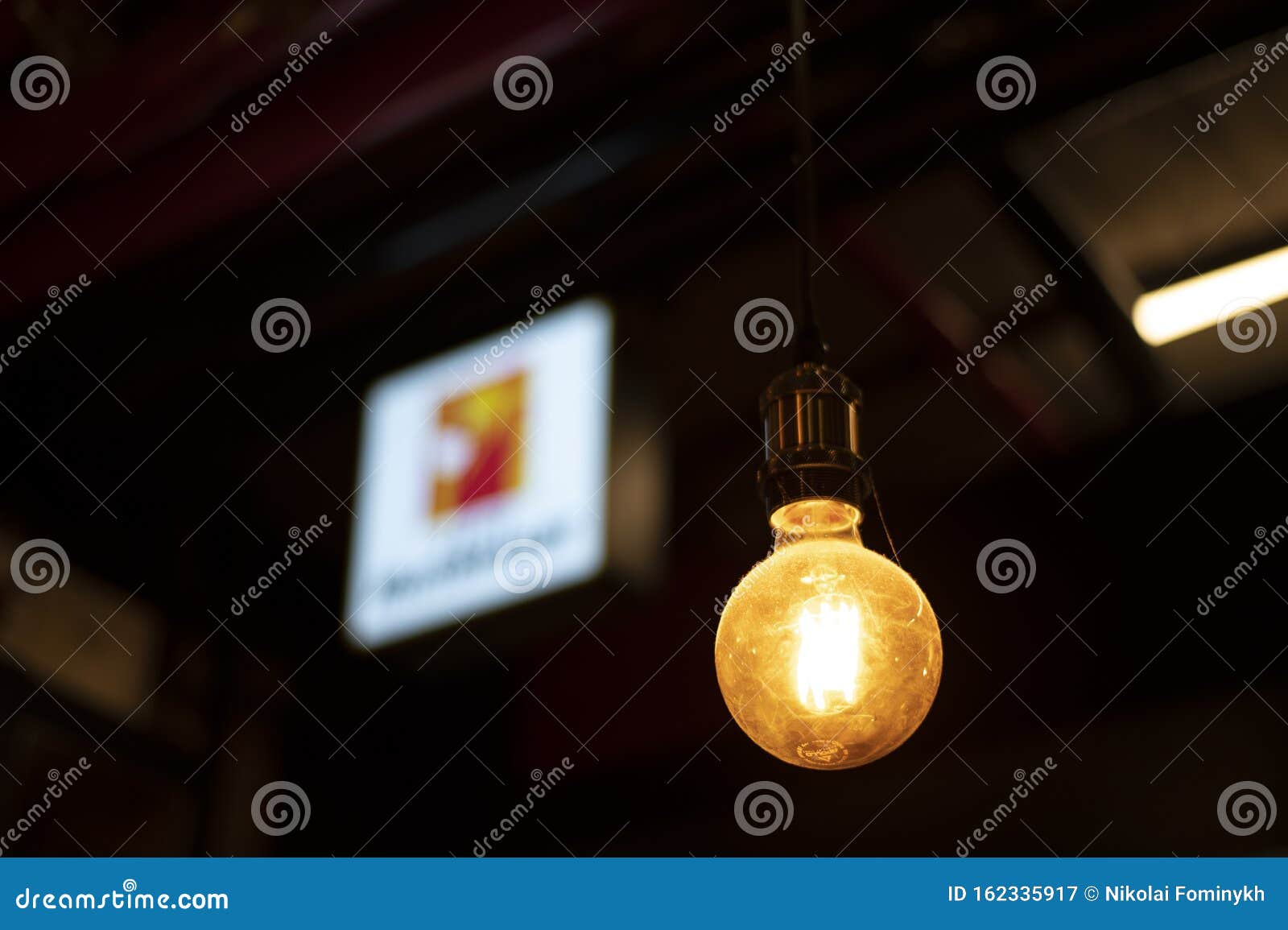 One Dusty Light Bulb in the Dark Hangs on a Black Wire Stock Image ...