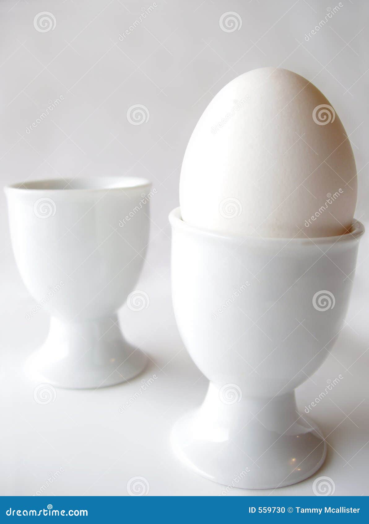 One egg - two egg cups stock photo. Image of breakfast - 559730
