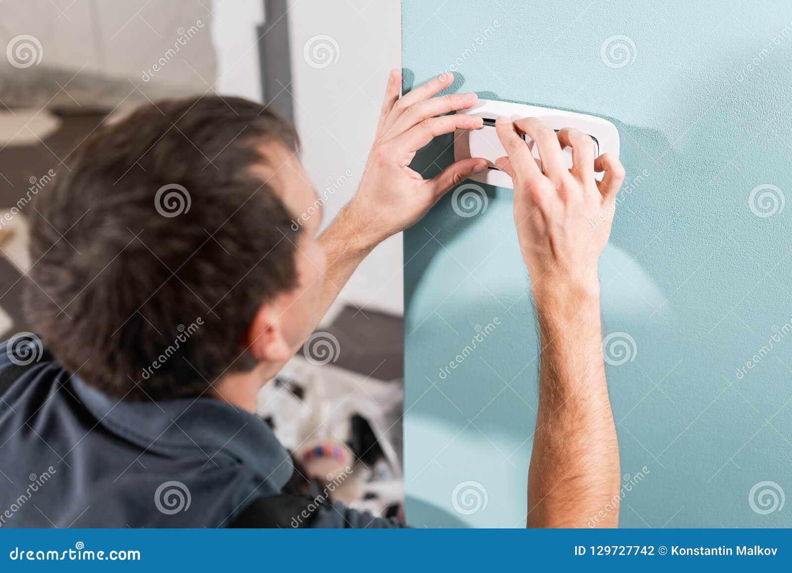 Electrician Worker Installs Light Switch and Socket on Wall in Room ...