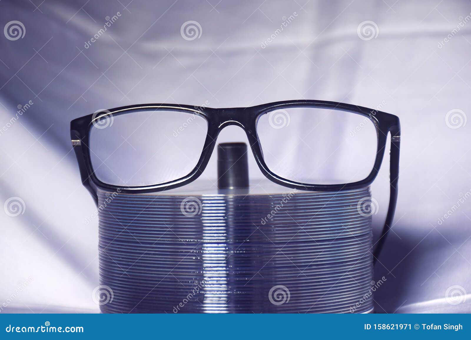One Eye Glasses on the Stack of Empty Disks with Grew Cloth Background ...