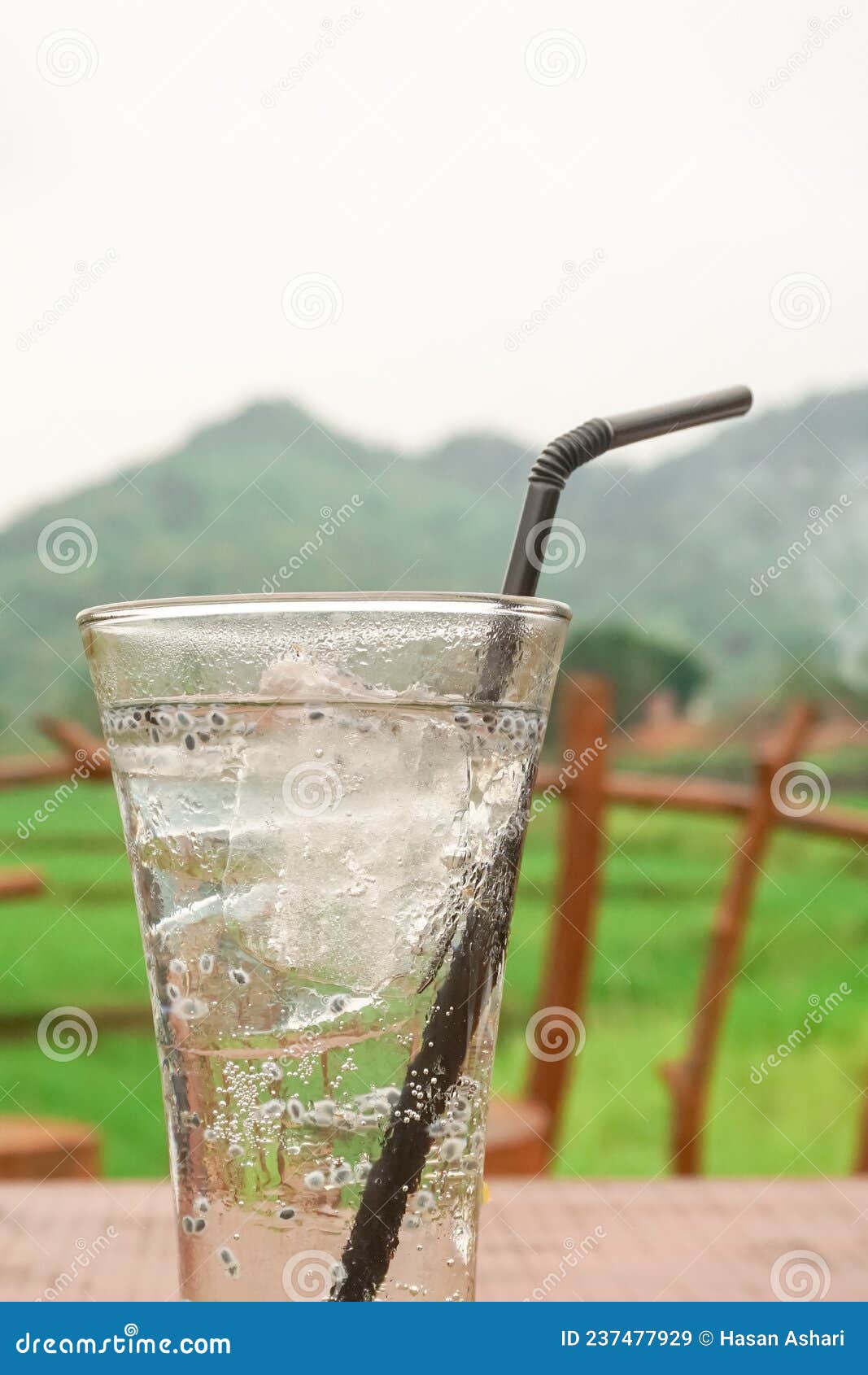 One Glass of Fresh Melon Squash Drink on a Table with Rice Fields and ...