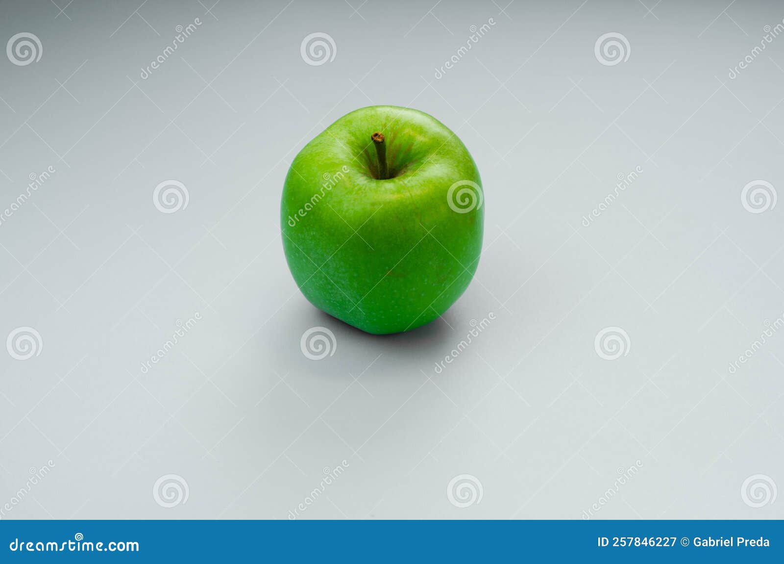 One Green Apple on a Light Blue Background with a Minimalistic ...