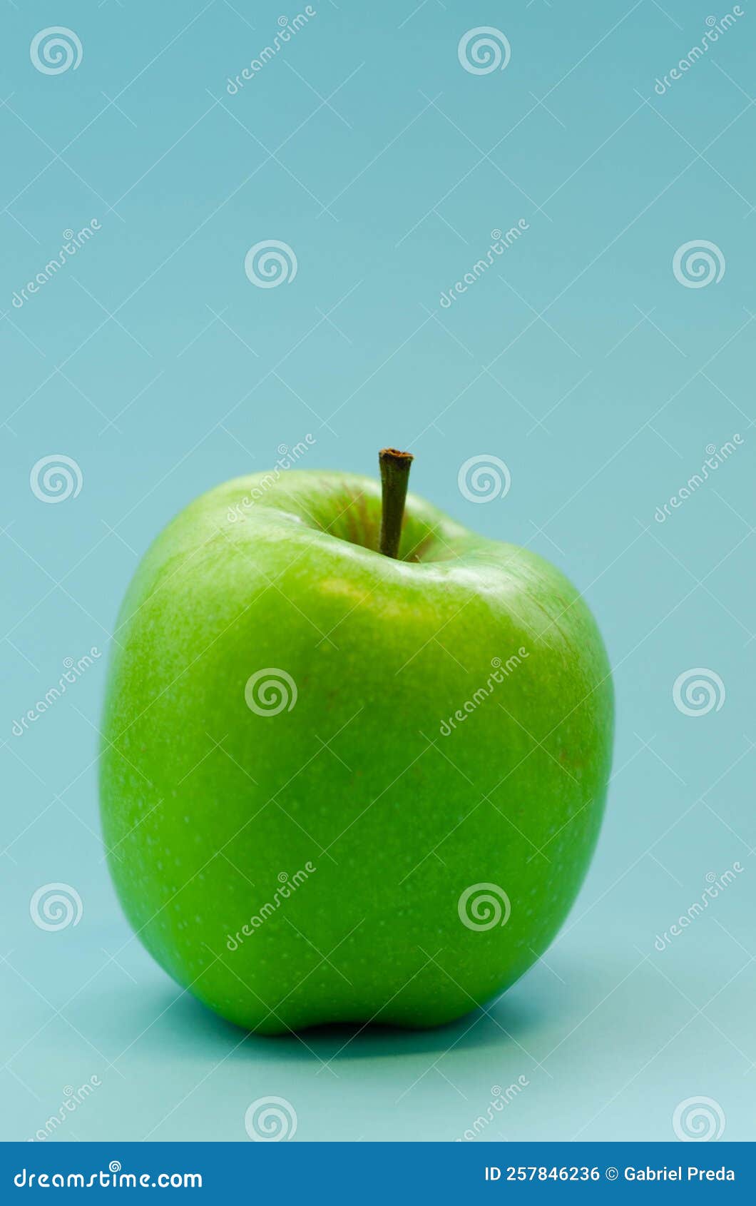 One Green Apple on a Light Blue Background with a Minimalistic ...