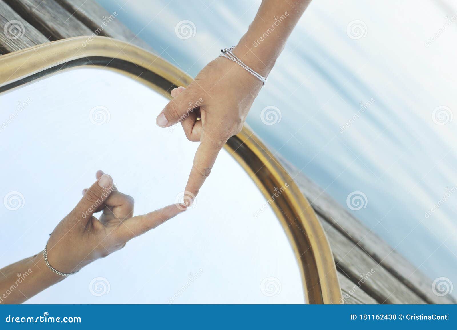 One Hand Gently Touches the Reflection of the Same Hand on the Mirror ...