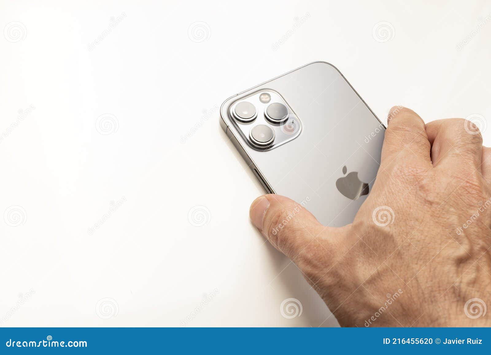 One Hand Holding the New Iphone 12 Pro Max Seen from the Back, on a ...