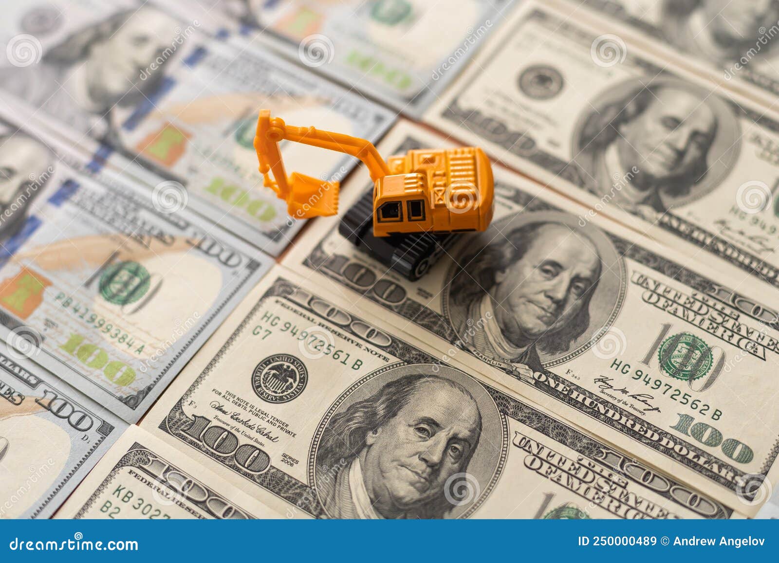 One Hundred Dollar Bills and a Toy Excavator Stock Image - Image of ...