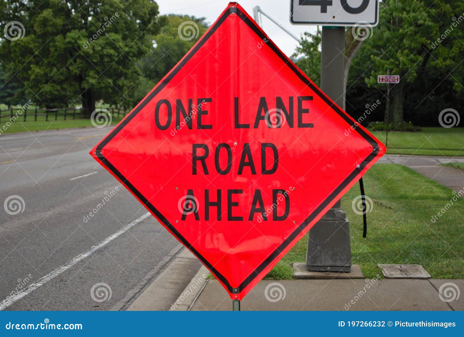 One Lane Road Ahead Construction Sign on the Side of a Five Lane Road ...