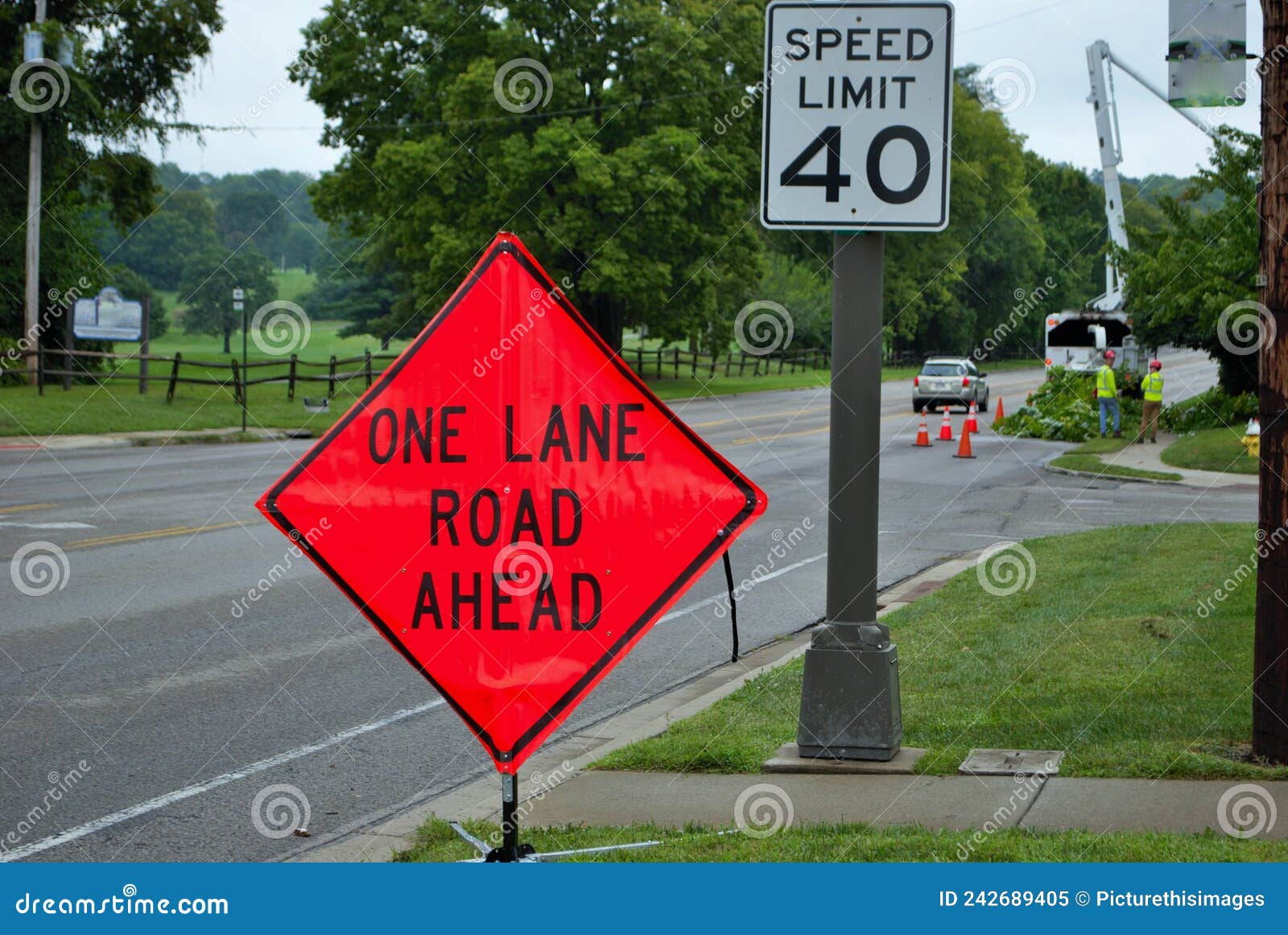 One Lane Road Ahead Construction Sign on the Side of a Five Lane Road ...