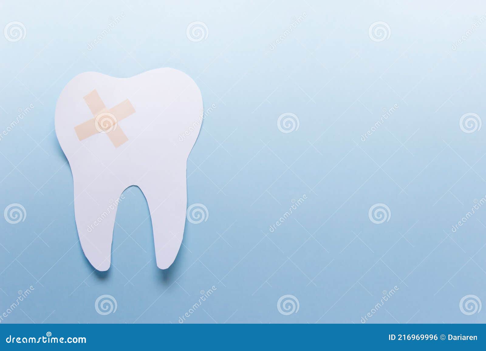 One Large Paper Tooth with Patch on Blue Background Stock Photo - Image ...