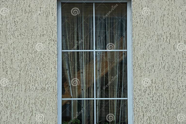 One Large Rectangular Window with a White Frame on the Gray Plastered ...