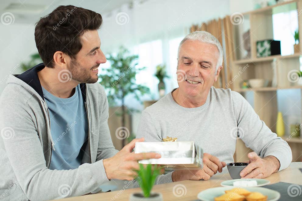 One Man Giving Present To Another Man Stock Image - Image of family ...