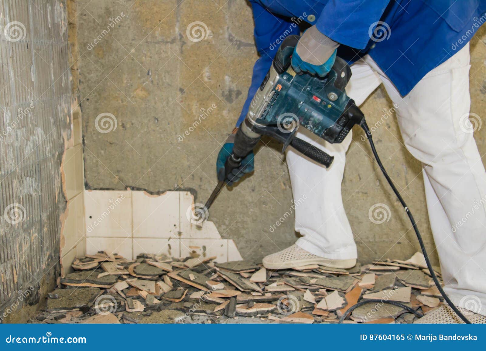 One Man Packs Tiles with a Demolition Hammer Stock Image - Image of ...