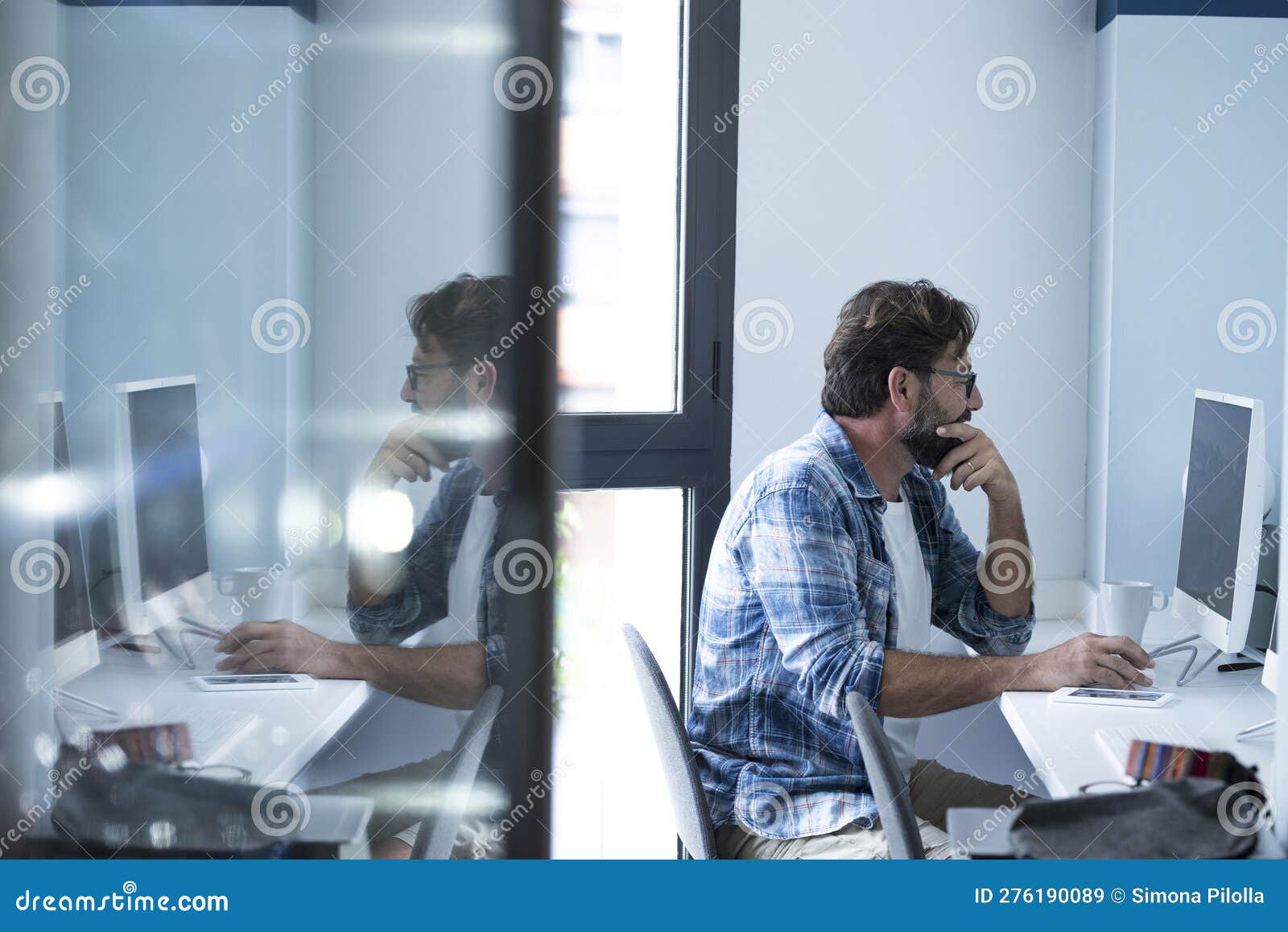 One Modern Worker Using Computer and Looking Screen with Doubts. Office ...