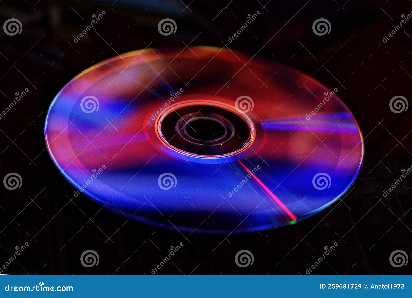 One Old Plastic Compact Disc with a Bright Red Blue Colored Reflection ...