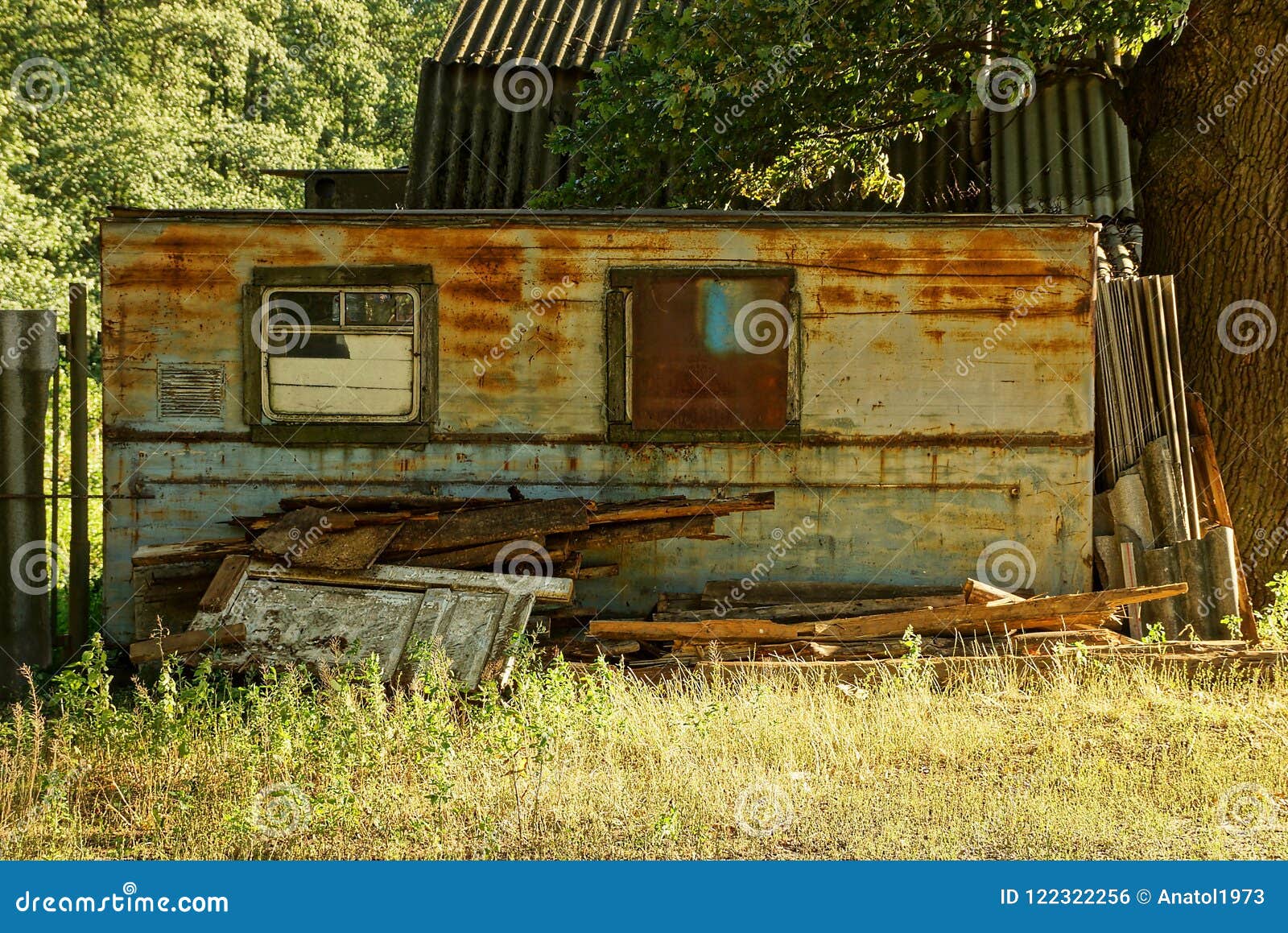 Old Rusty Trailer with Windows in the Grass on the Street Stock Photo ...