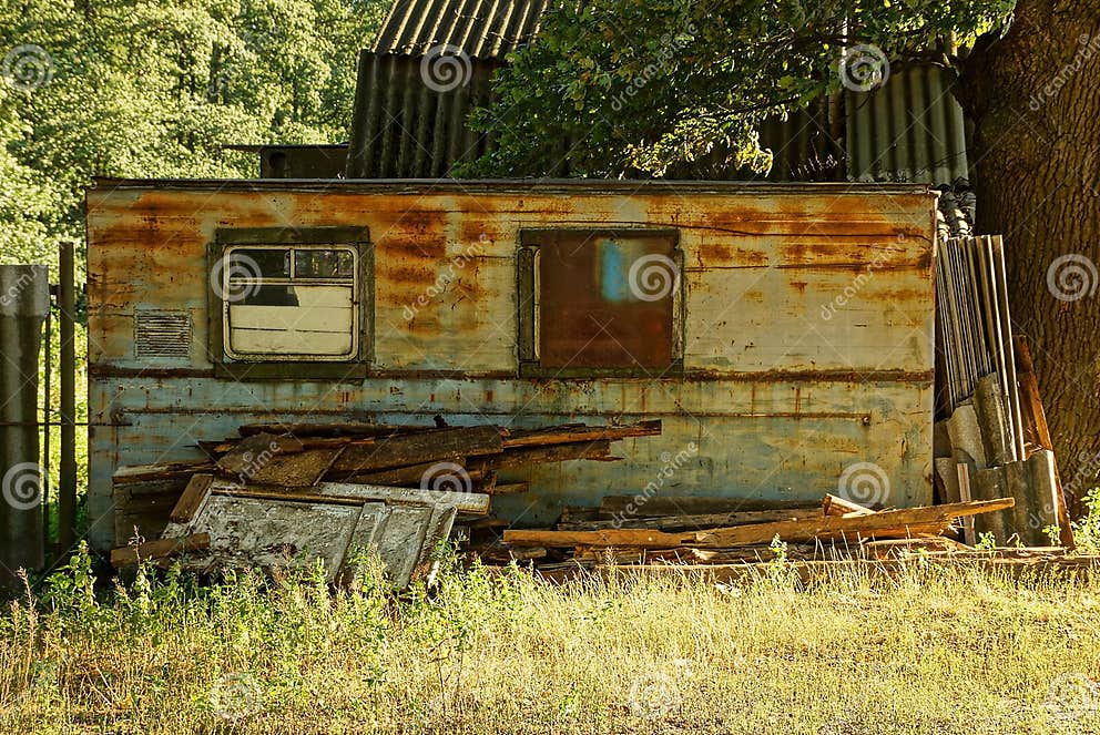 Old Rusty Trailer with Windows in the Grass on the Street Stock Photo ...