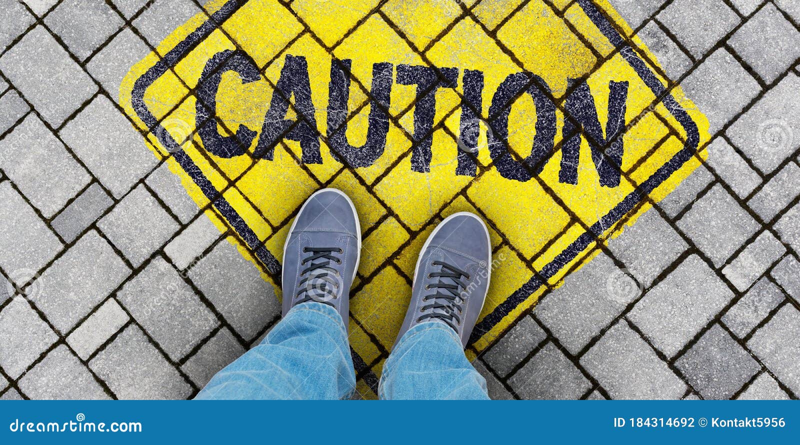 One Person is Standing on the Street with Caution Sign on Pavement ...