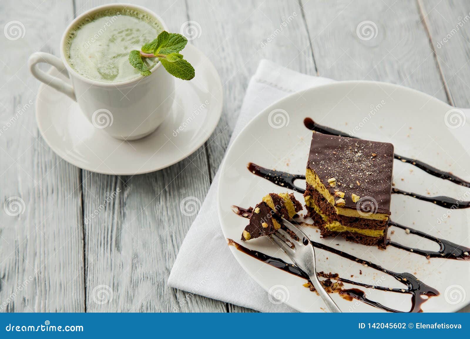 Piece of Austrian Three-layer Cake and Cup of Matcha Tea on a White ...