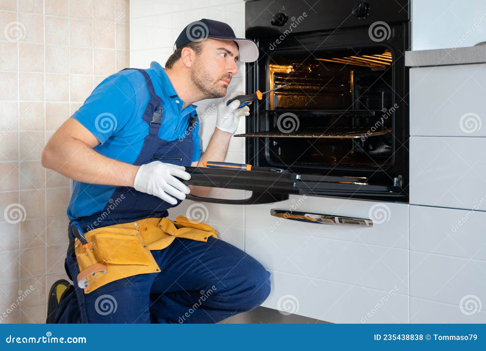 One Repairman Fixing Malfunctioning Kitchen Oven Problem Stock Photo ...