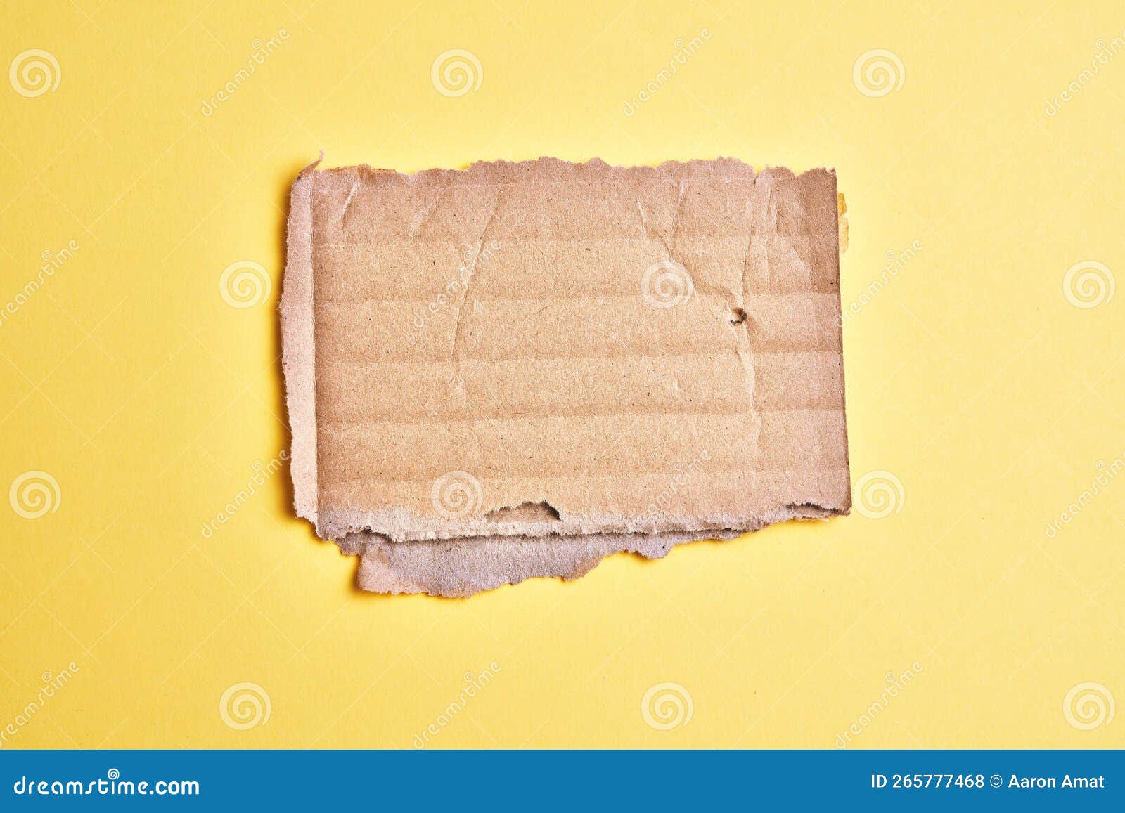 One Ripped Piece of Cardboard Material Over Isolated Yellow Background ...