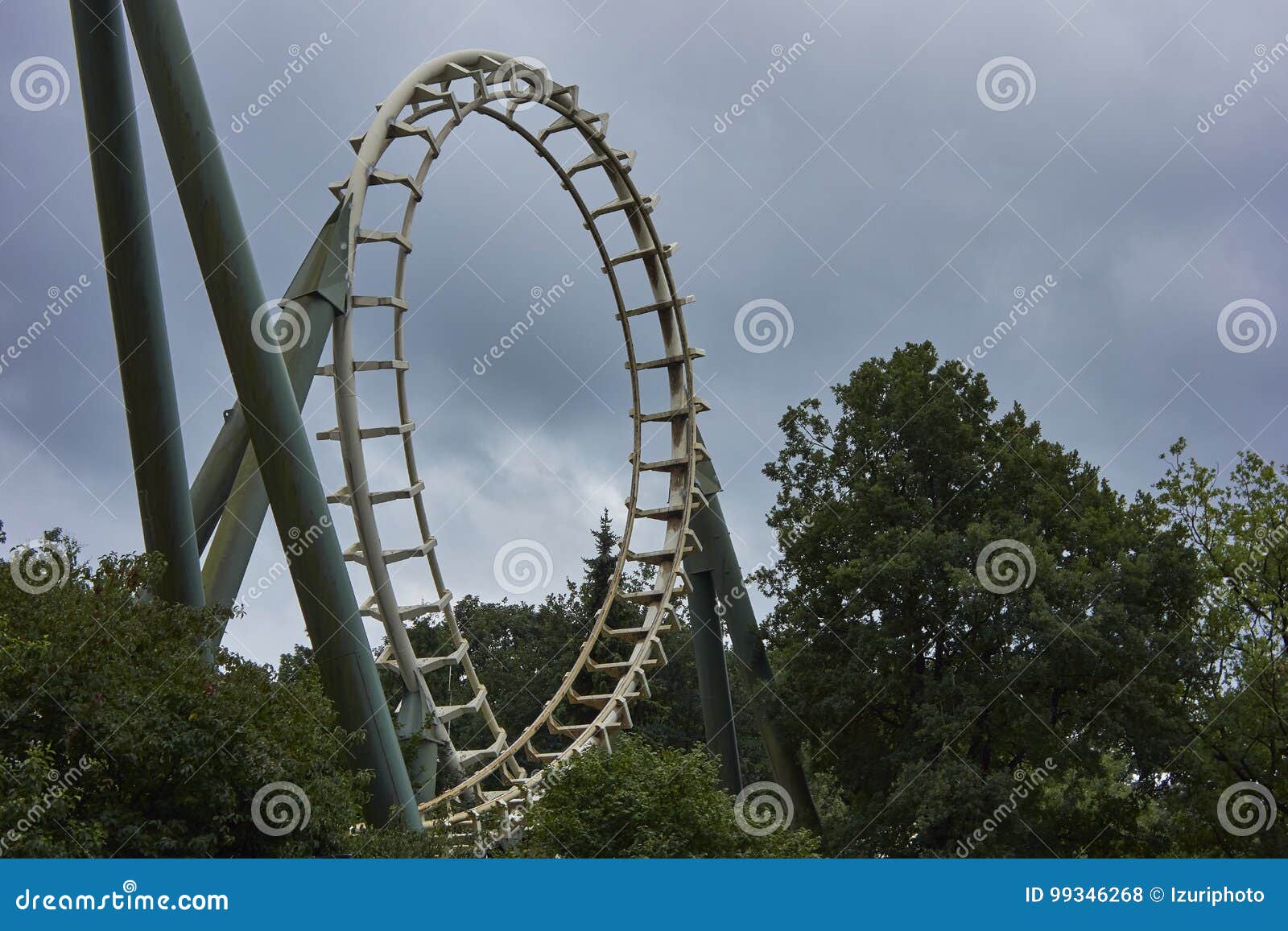 One Roller Coaster Loop in Green Foliage Against Cloudy Sky Stock Photo ...