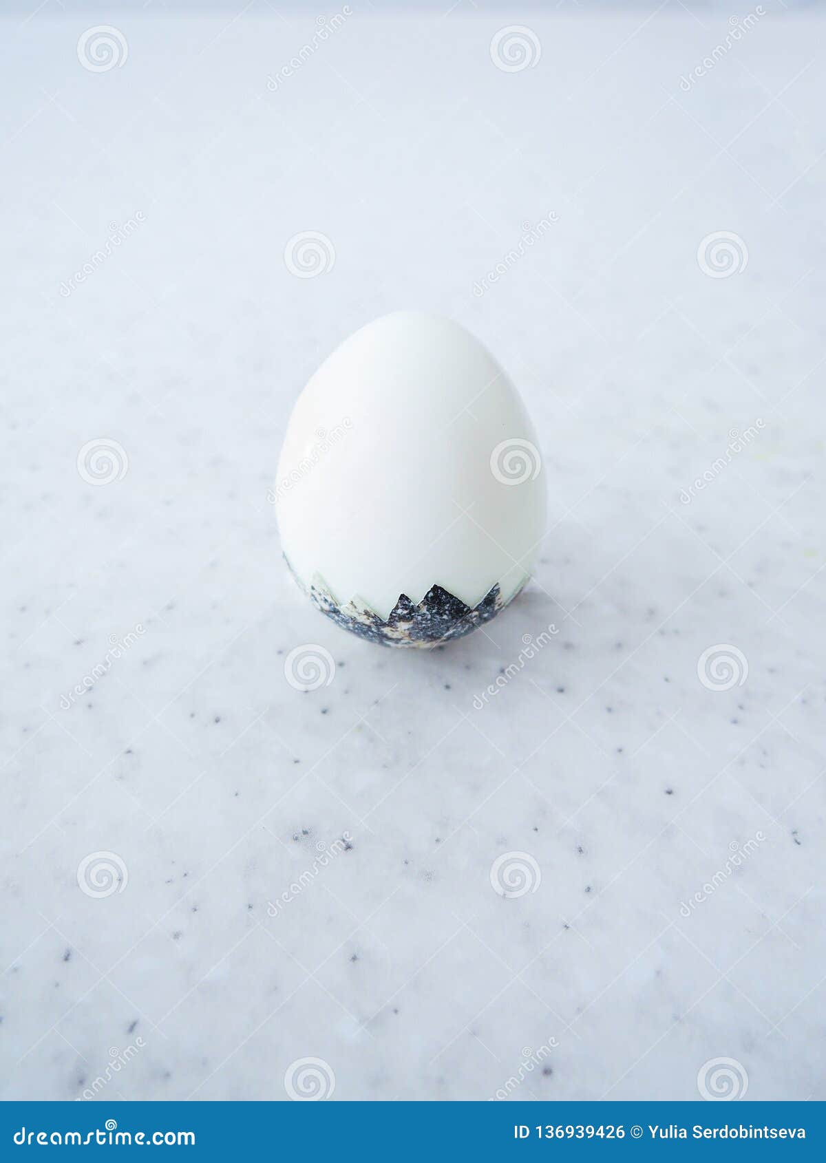 One Semi-peeled Egg Partially in a Shell on a Marble Background Stock ...